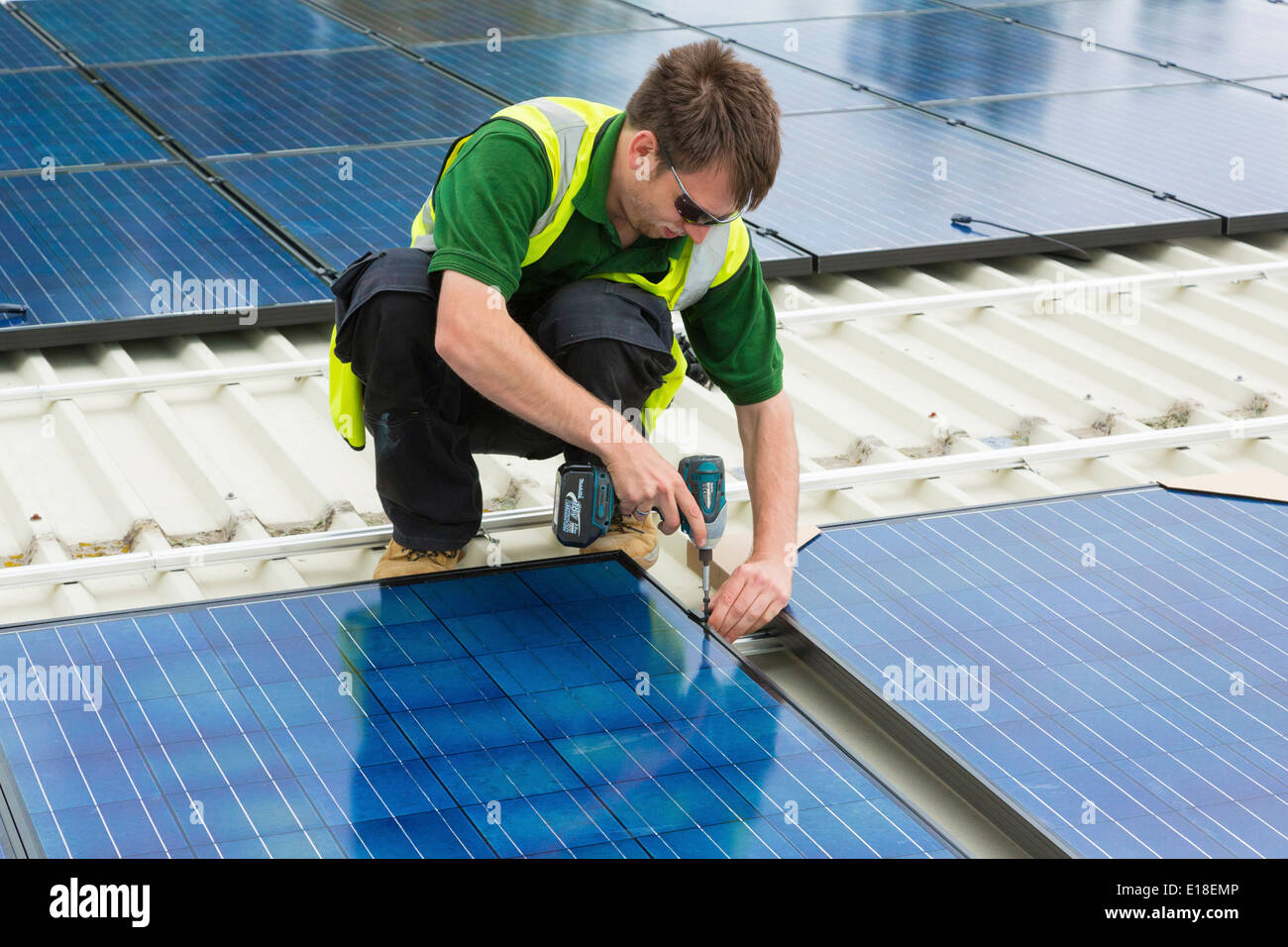 photovoltaic solar panels being installed on a roof Stock Photo - Alamy
