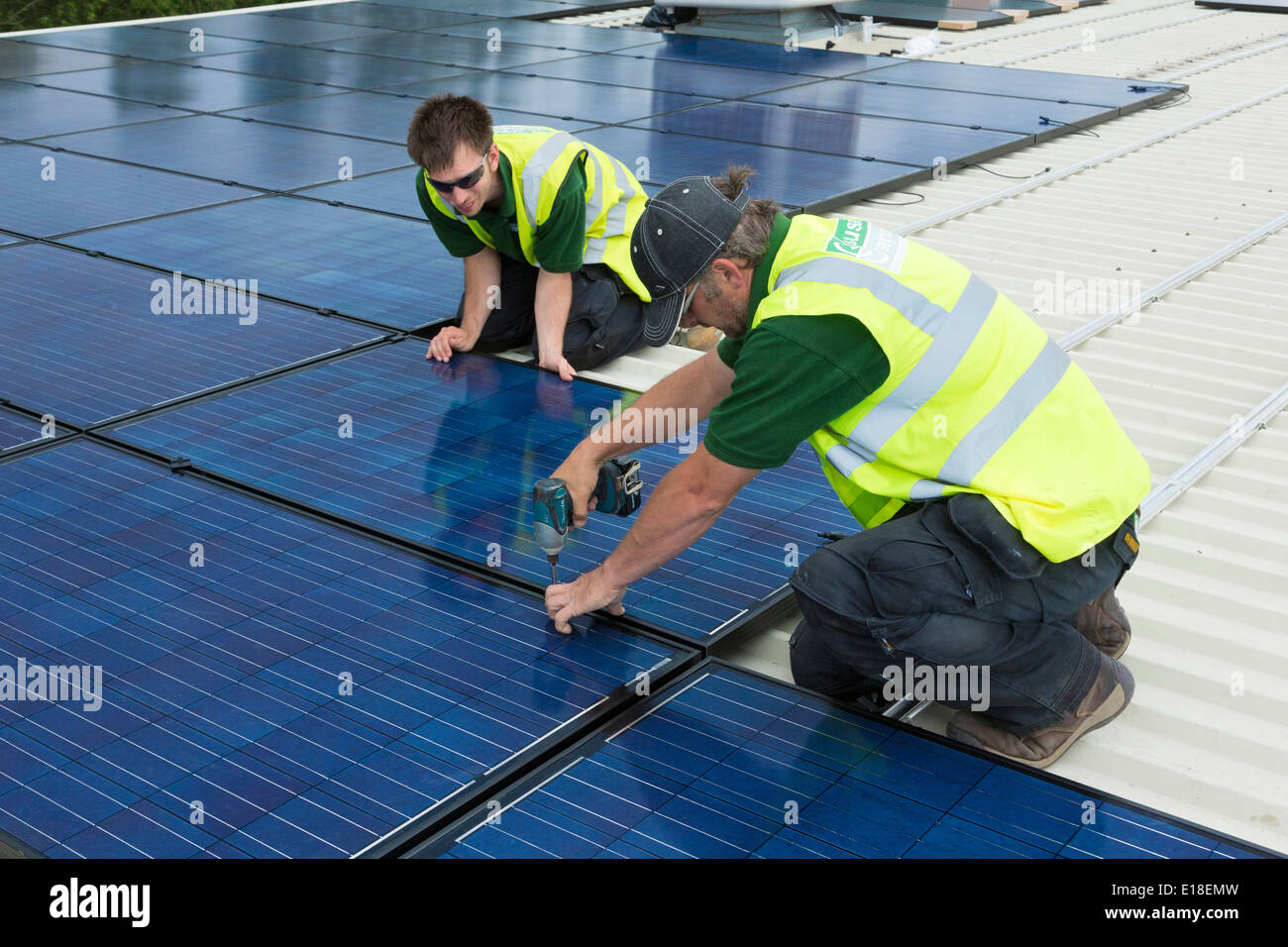 photovoltaic solar panels being installed on a roof Stock Photo - Alamy
