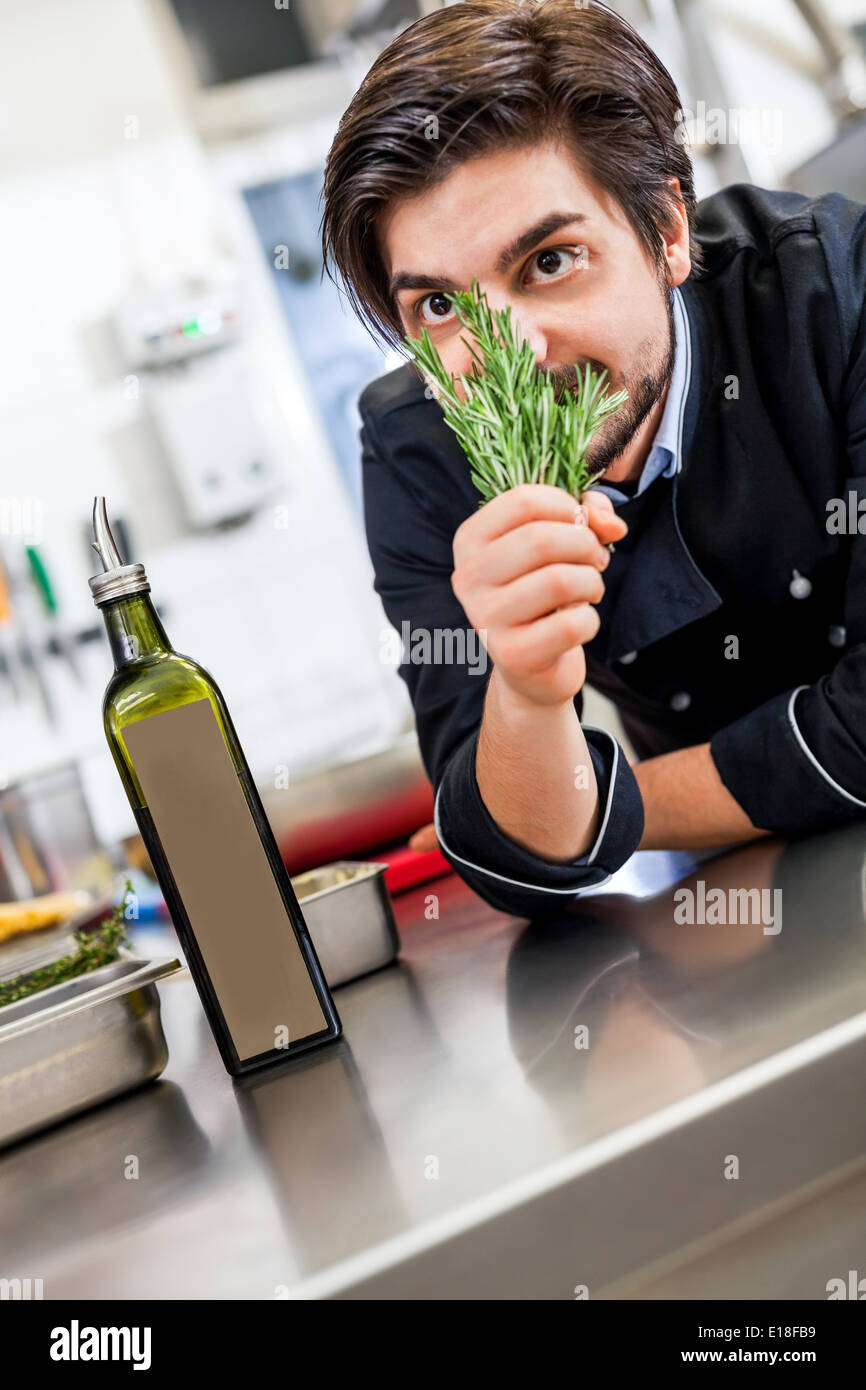 Attractive friendly chef preparing food Stock Photo - Alamy