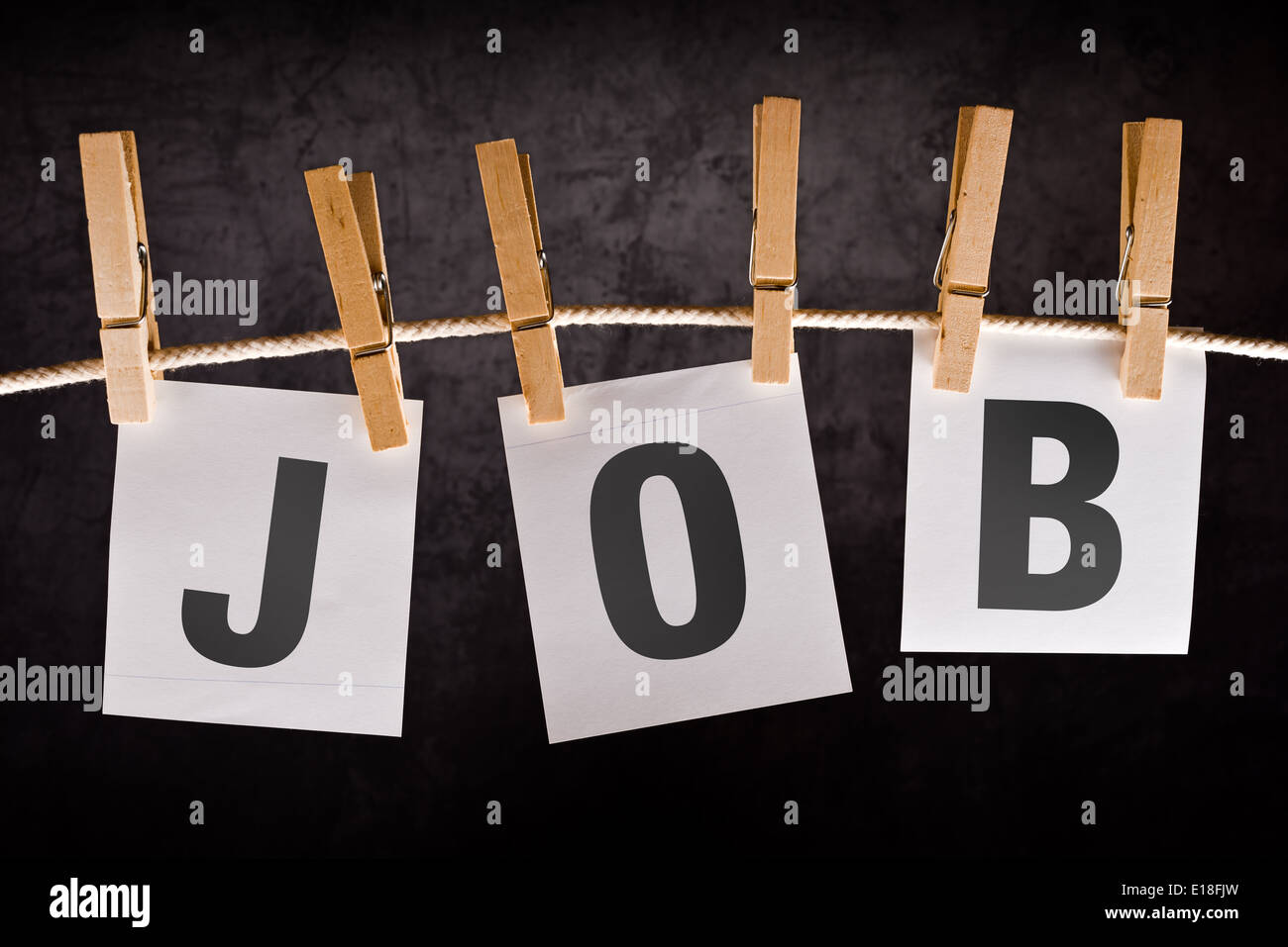 Note papers with printed word JOB hanging on clothes rope. Getting a ...