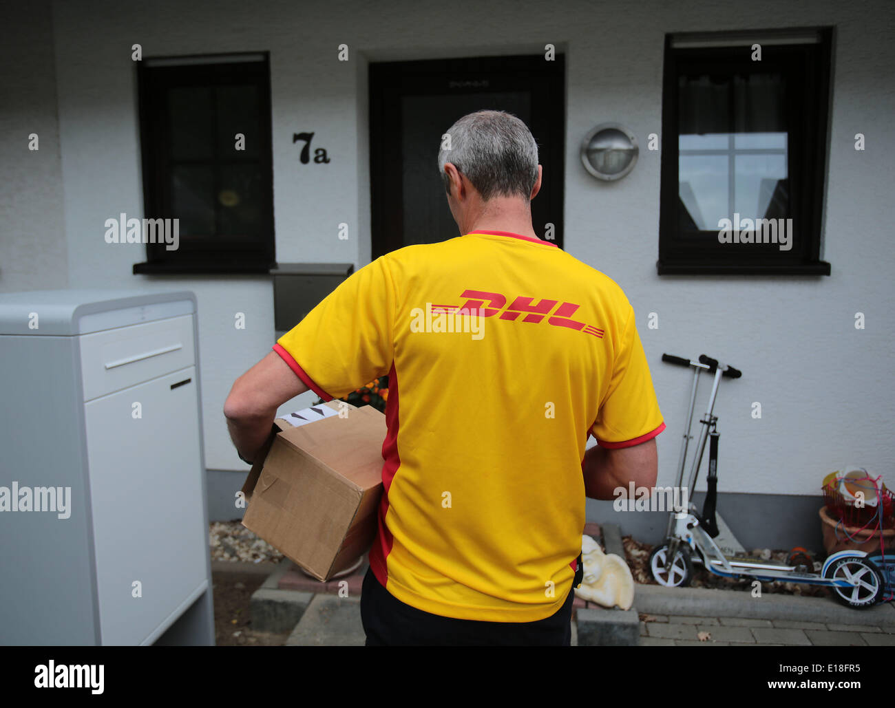 Koenigswinter, Germany. 26th May, 2014. A DHL parcel deliverer of ...