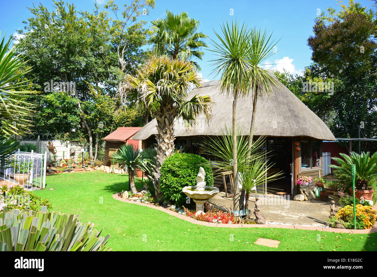 Thatched lapa building in garden of suburban house, Selcourt, Springs ...