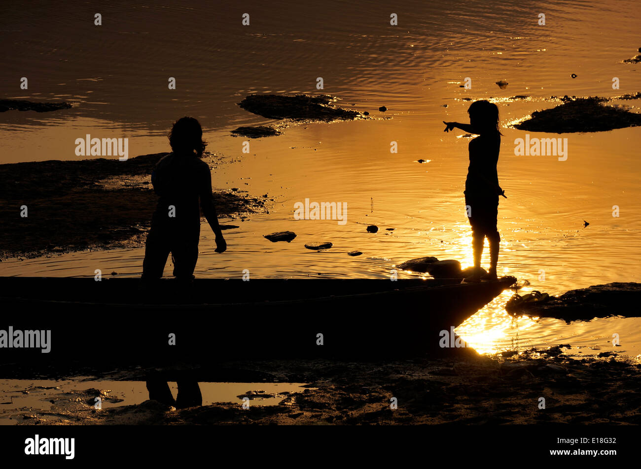Two human back lit, at the red sunset on the lake Stock Photo - Alamy