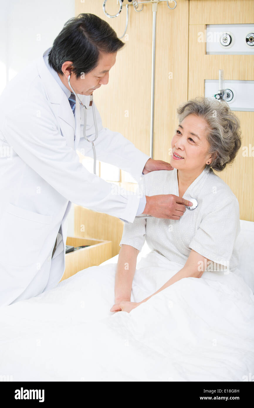 Chinese doctor examining patient in hi-res stock photography and images ...