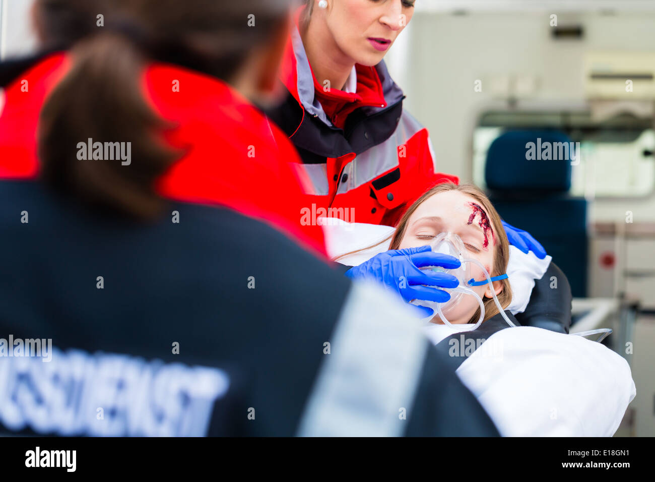 Emergency doctor and nurse or ambulance team transporting accident ...