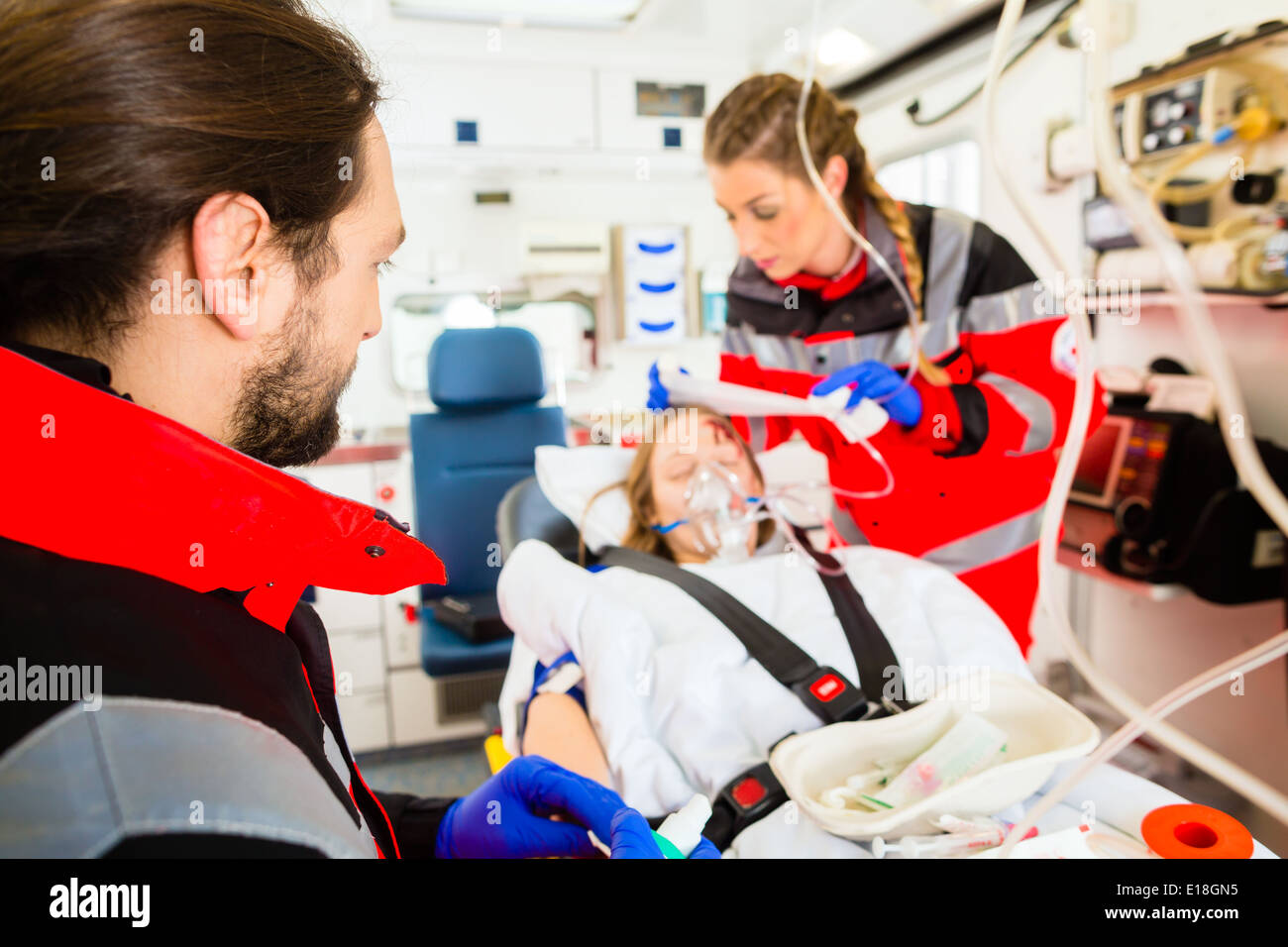 Emergency doctor and nurse or ambulance team medicate accident victim ...