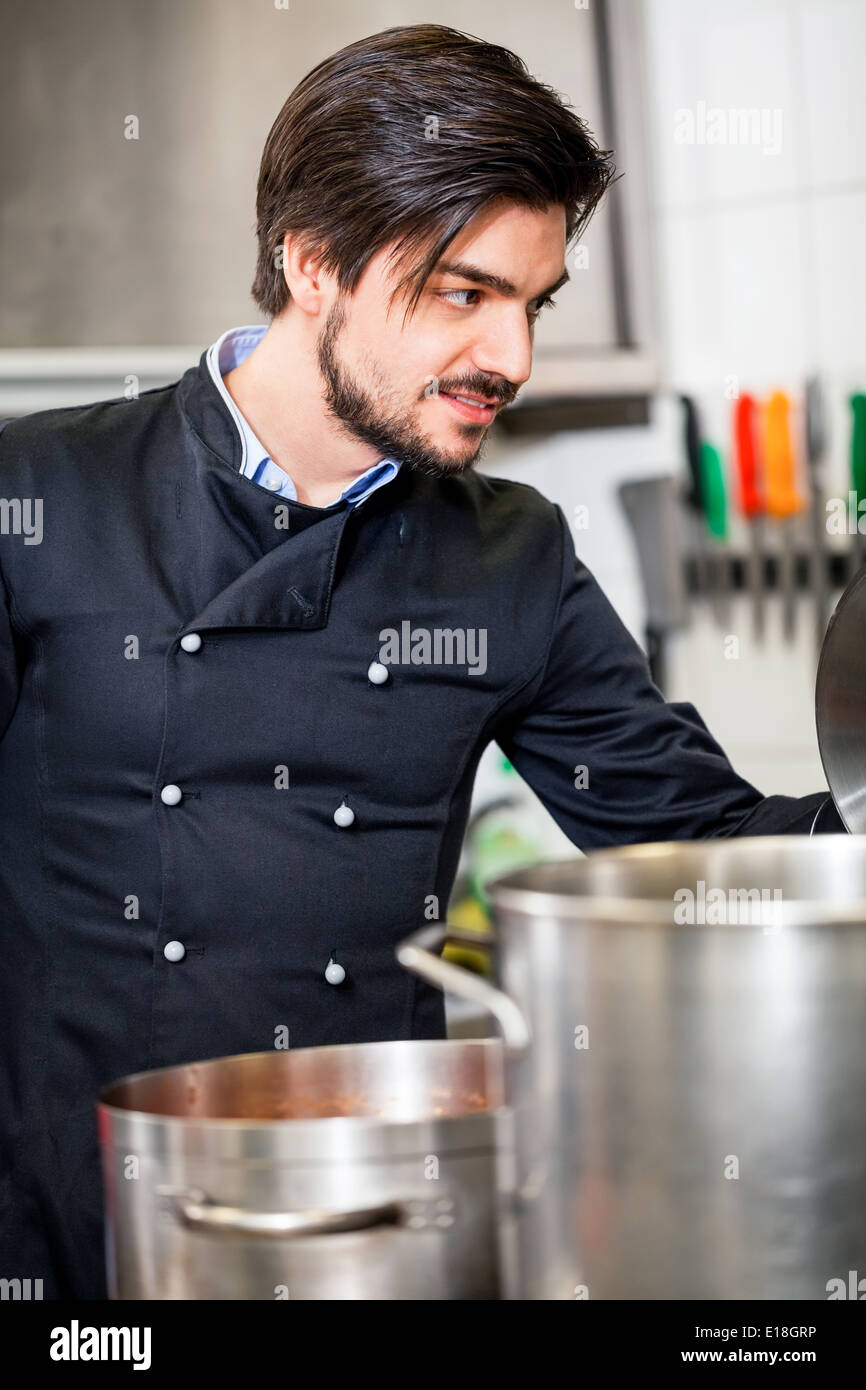 Attractive friendly chef preparing food Stock Photo - Alamy