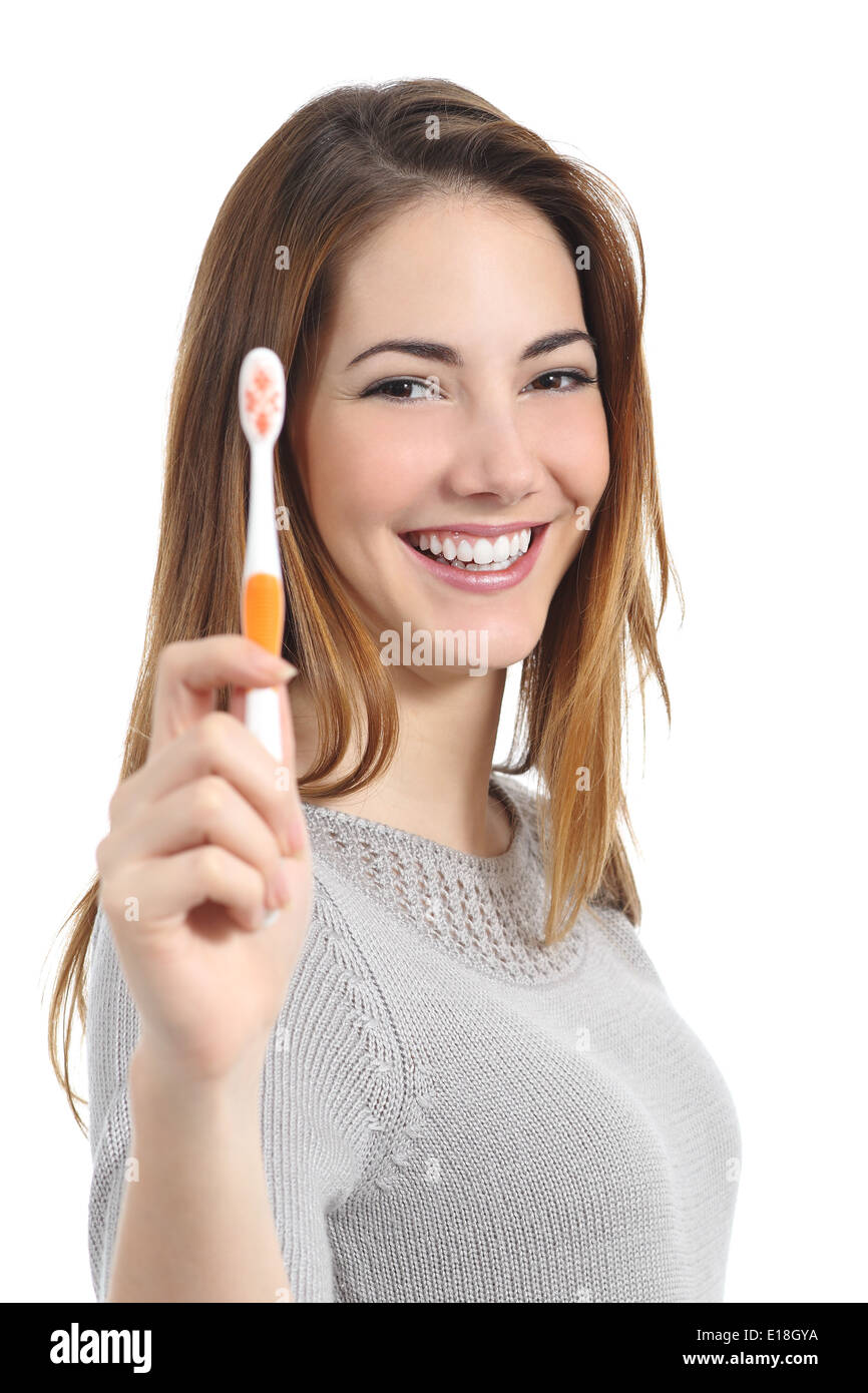 Woman portrait with a perfect white smile holding a toothbrush isolated ...