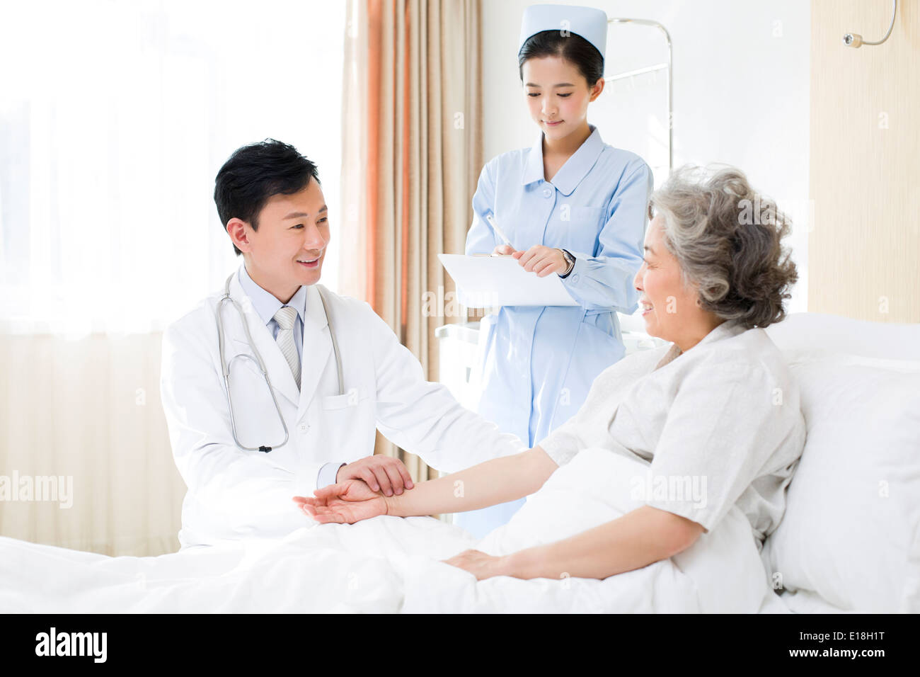 Doctor taking pulse of patient in hospital Stock Photo - Alamy