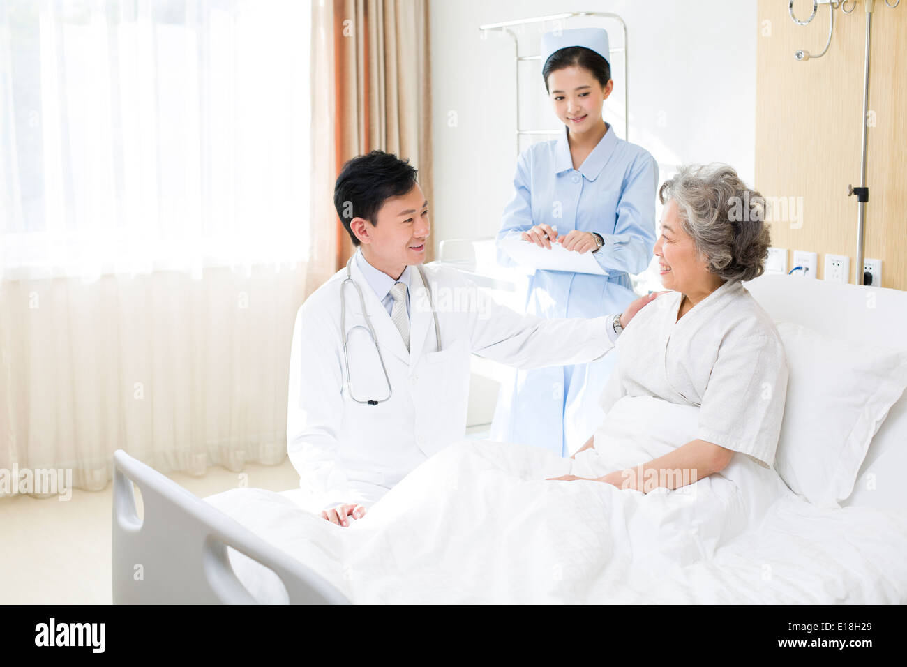 Medical workers with patient in hospital Stock Photo - Alamy