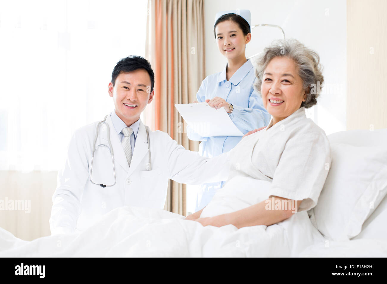 Medical workers with patient in hospital Stock Photo - Alamy