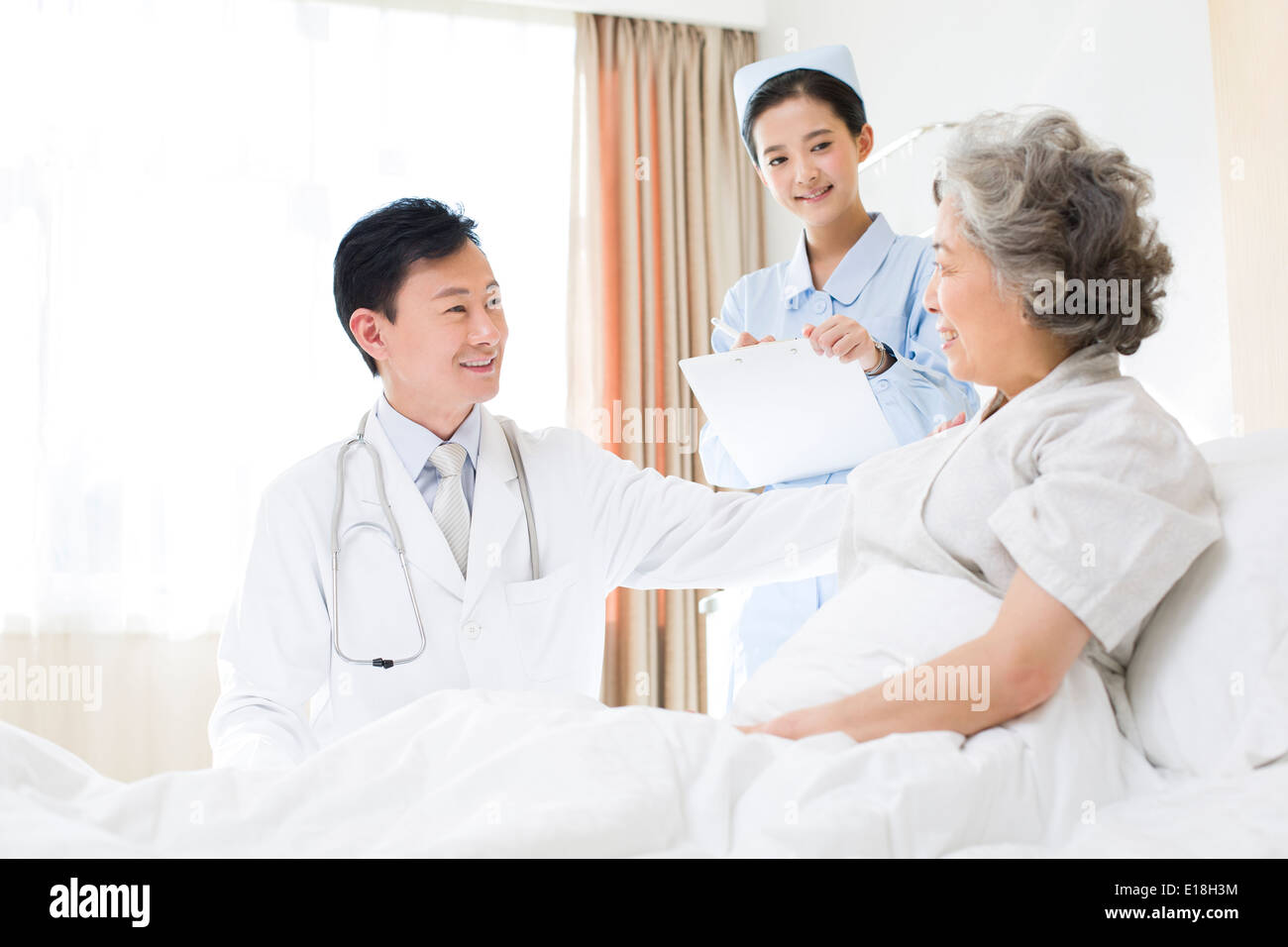 Medical workers with patient in hospital Stock Photo - Alamy