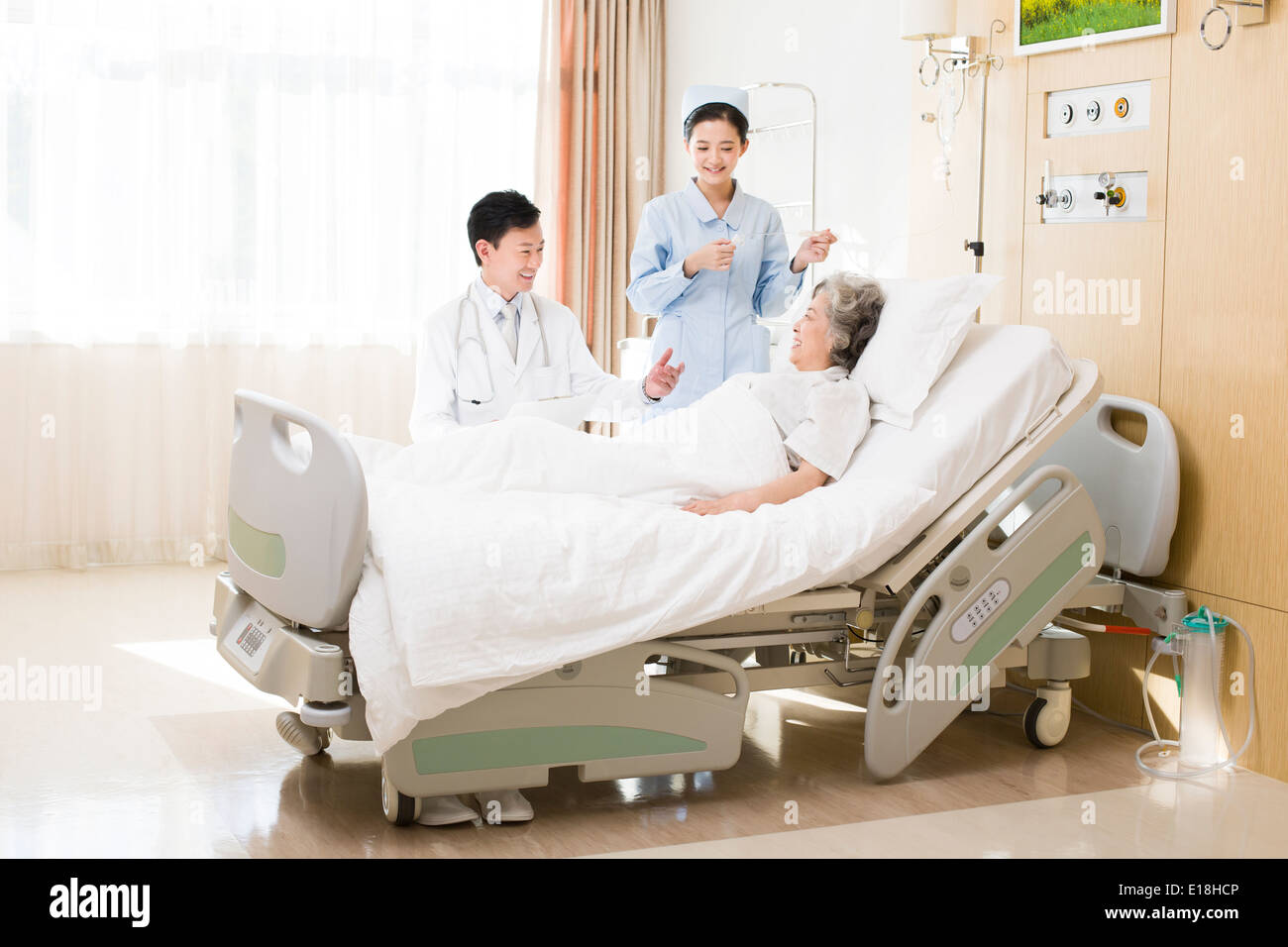 Medical workers with patient in hospital Stock Photo - Alamy