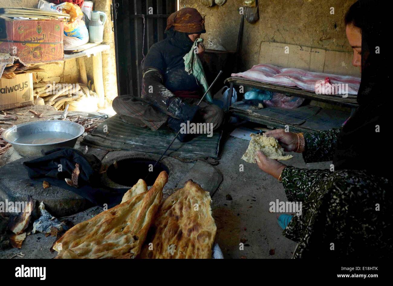 Kabul, Afghanistan. 27th May, 2014. Afghan women make bread at a bakery ...