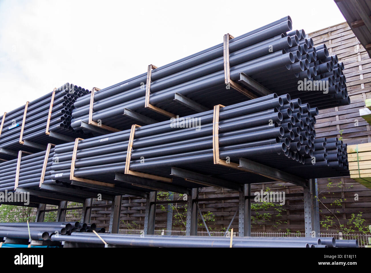 Rolls of plastic pipes in a warehouse yard Stock Photo - Alamy