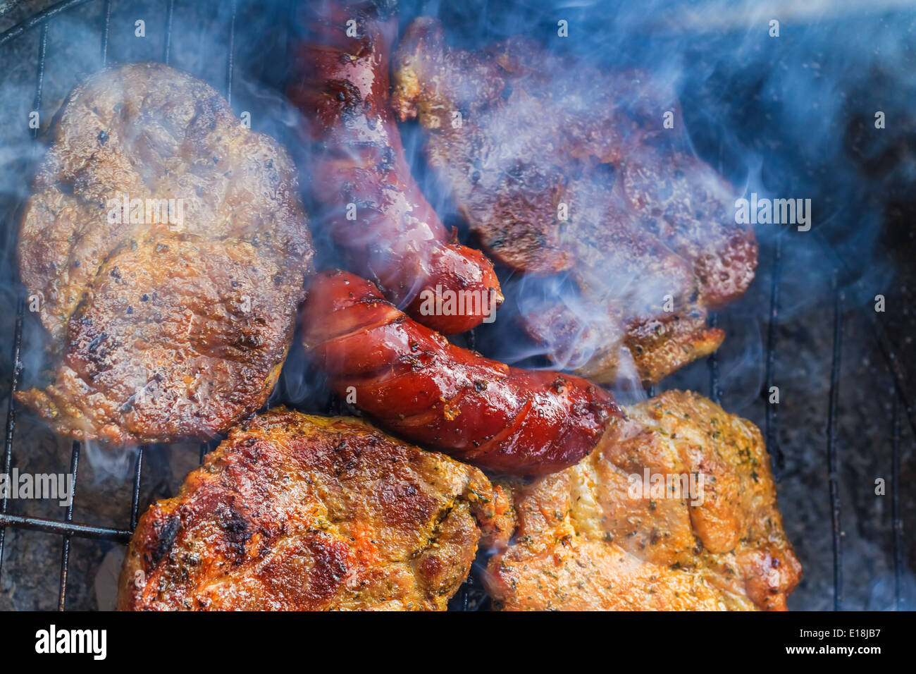 Barbecue in the garden. Process of cooking meat on grill Stock Photo ...
