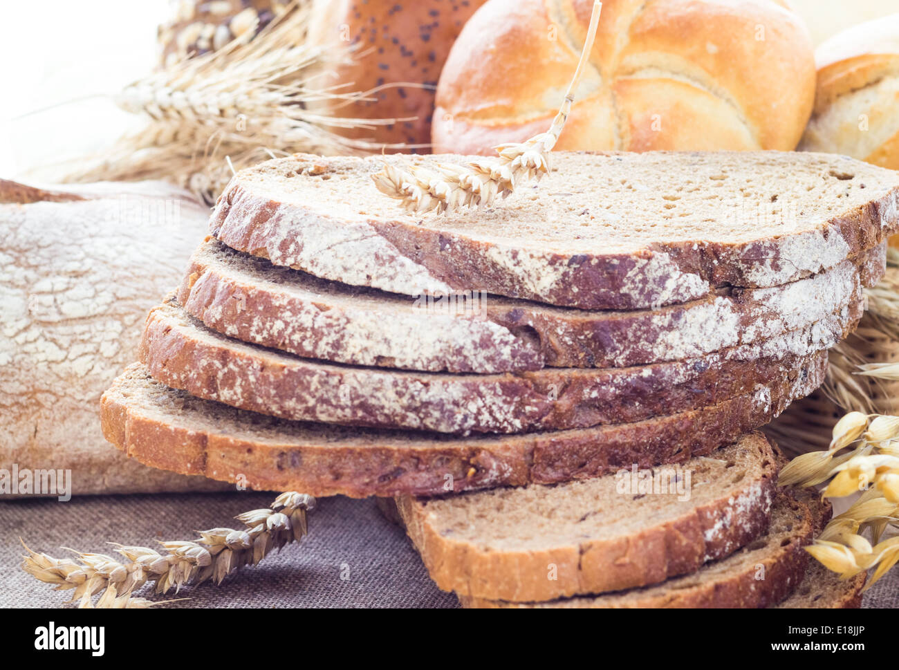 Loaf of bread sliced with crispy rolls Stock Photo - Alamy