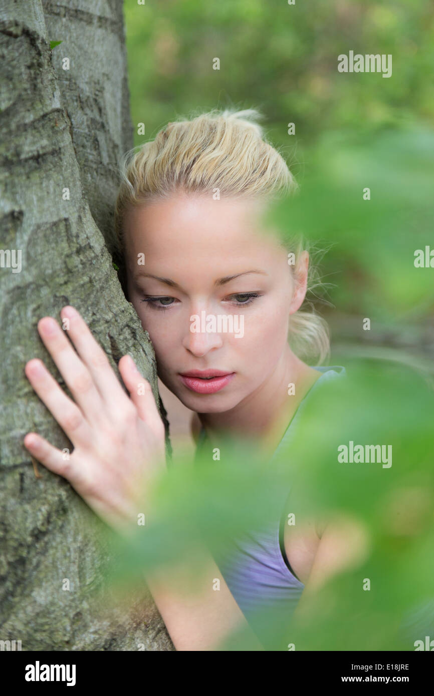 Young woman hugging a tree Stock Photo - Alamy
