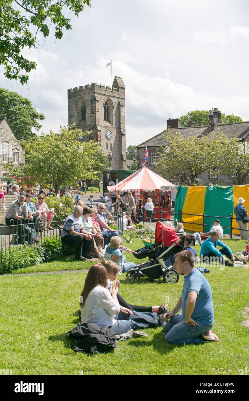 Families sitting on village green Rothbury street fair, May bank ...