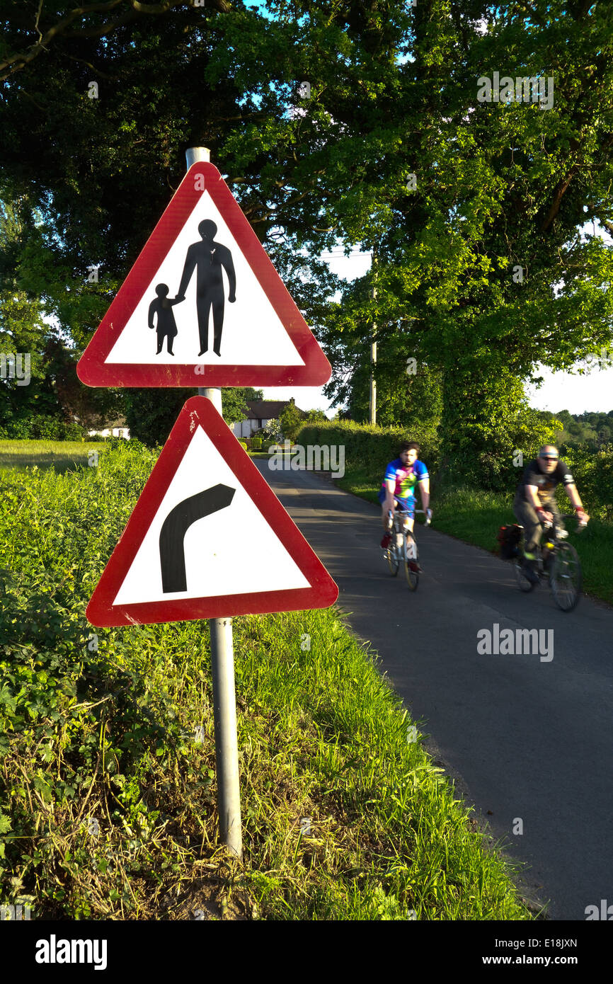 pedestrian and bend warning sign on country lane Stock Photo - Alamy