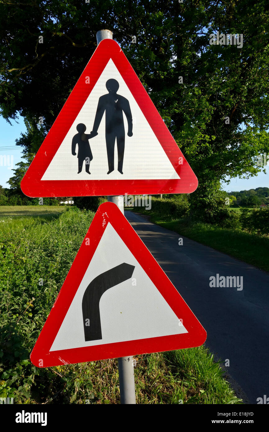 pedestrian and bend warning sign on country lane Stock Photo - Alamy