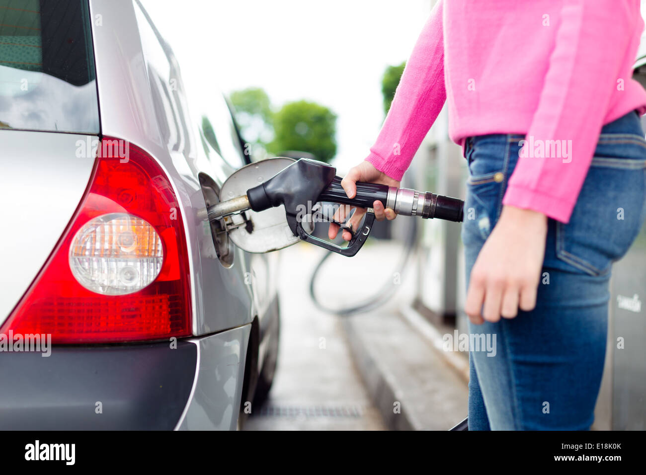 Lady pumping gasoline fuel in car at gas station Stock Photo - Alamy