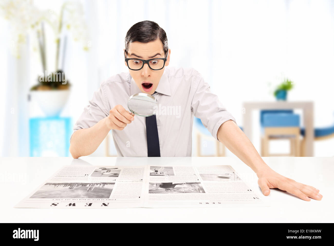 Reading newspaper magnifying glass hi-res stock photography and images ...