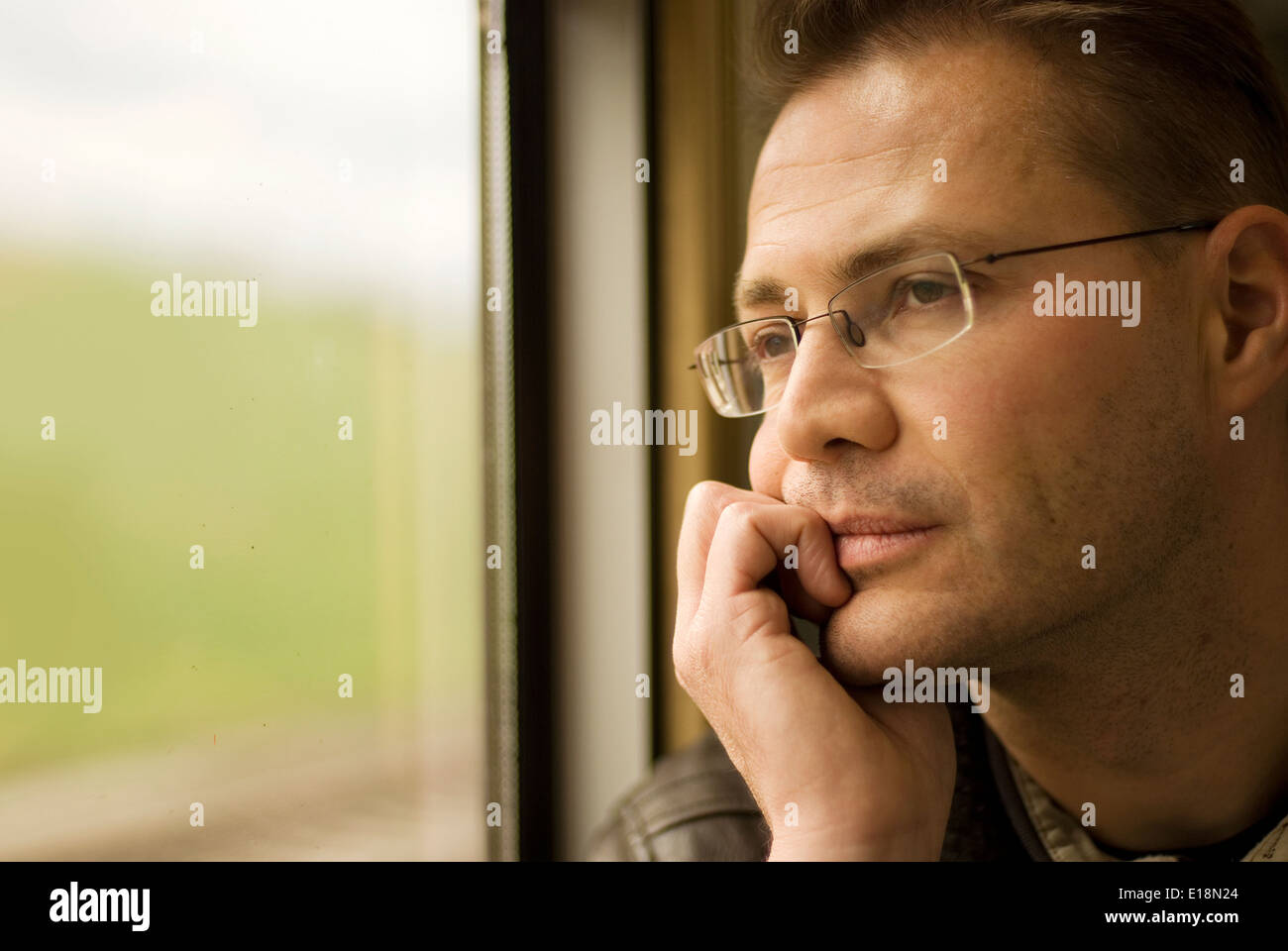 Thinking man looking in a window Stock Photo - Alamy