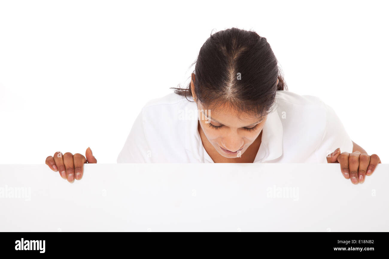 Attractive indian woman behind white wall Stock Photo - Alamy