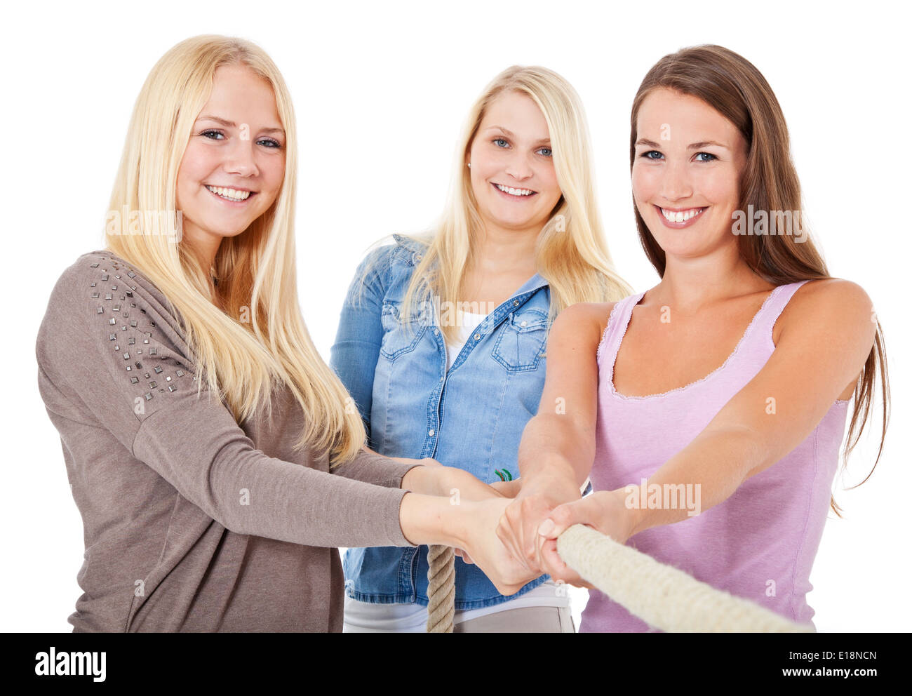 Three attractive girls pulling heavy rope Stock Photo - Alamy