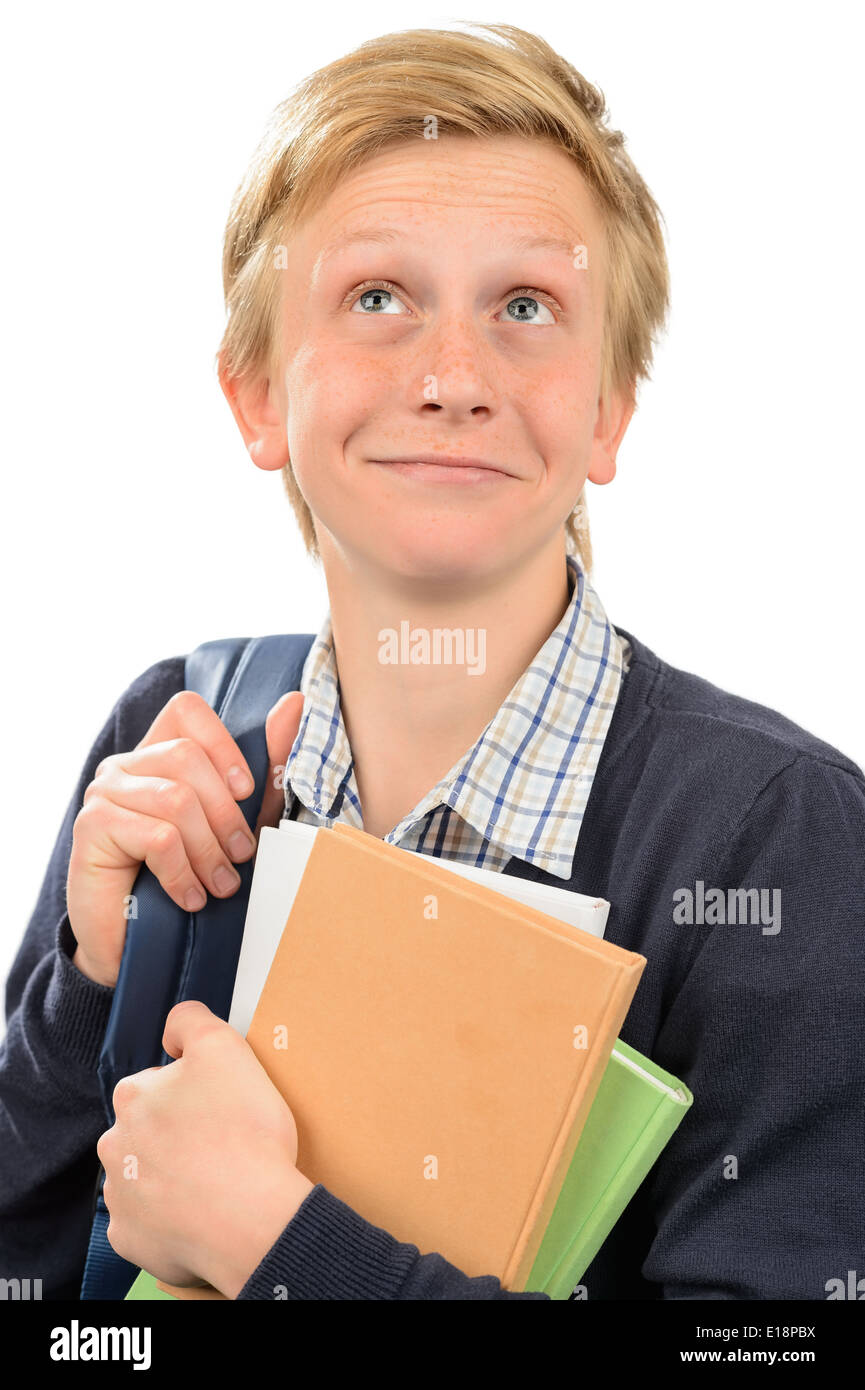 Thoughtful teenage student boy holding books against white background ...
