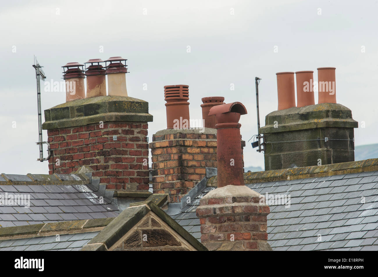 Groups of chimneys on house rooftops Stock Photo - Alamy