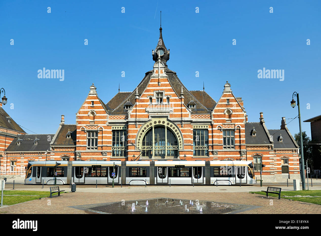A tram passing in front of the entrance of the Schaerbeek Train Station ...