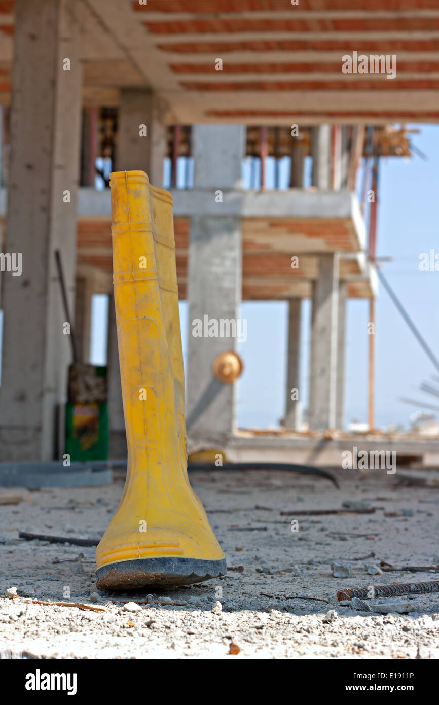 Yellow safety boots on a building site Stock Photo - Alamy
