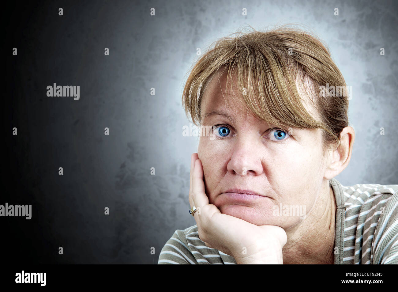 Sad woman looking into the camera Stock Photo - Alamy