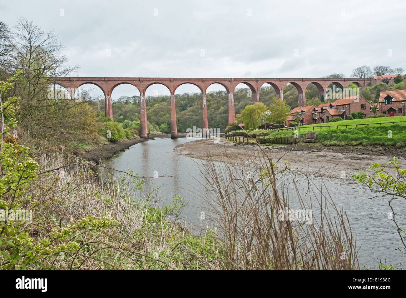 Large old viaduct structure spanning a river in english rural ...