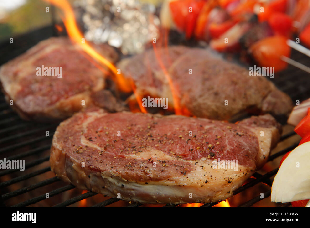 food cooking grilling flames bbq ribeye steaks grill Stock Photo - Alamy