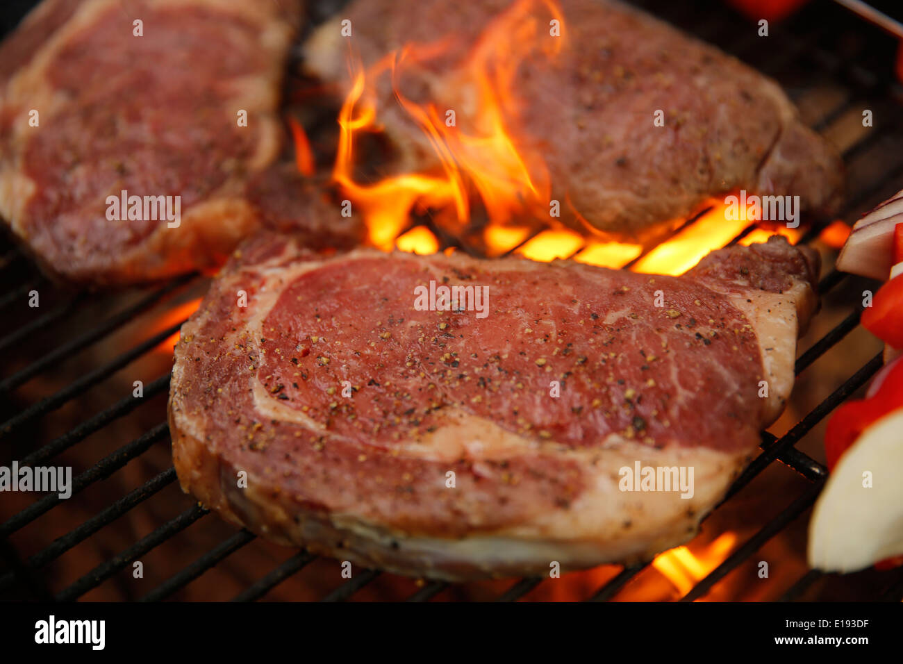 food cooking grilling flames bbq ribeye steaks grill Stock Photo - Alamy