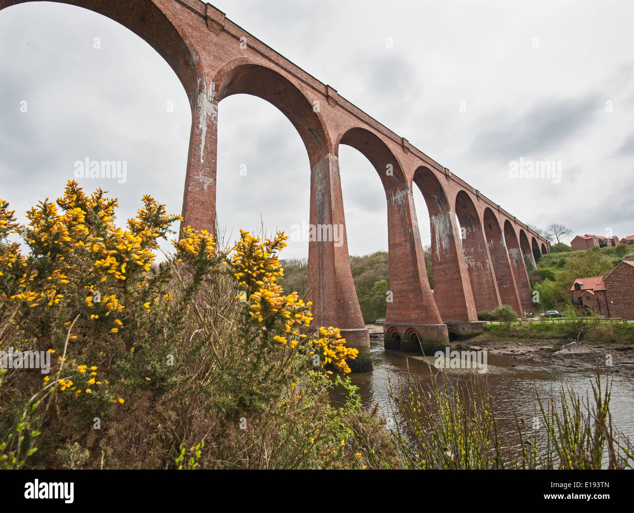 Large old viaduct structure spanning a river in english rural ...