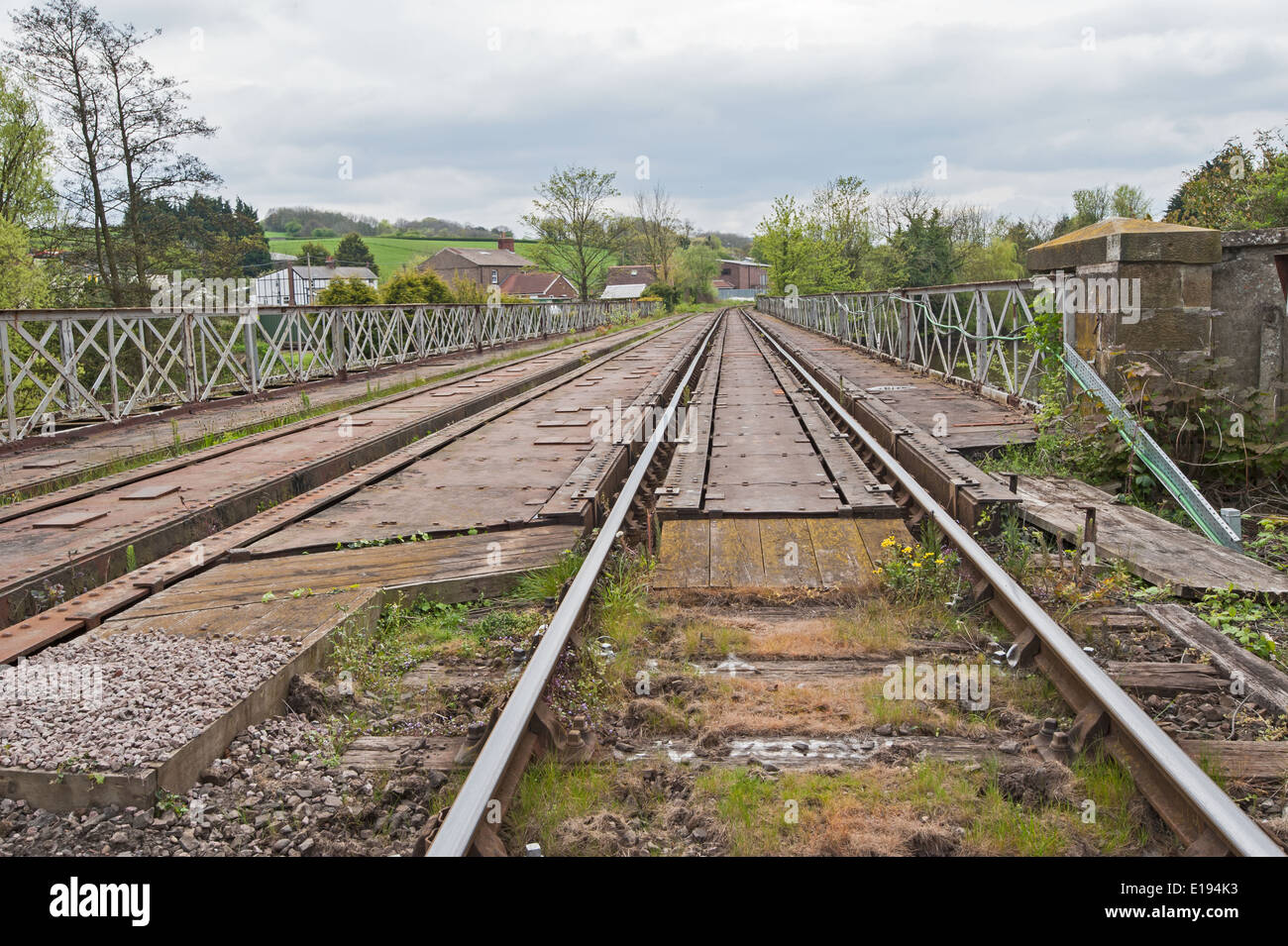 View down railway track over bridge in english rural countryside with ...
