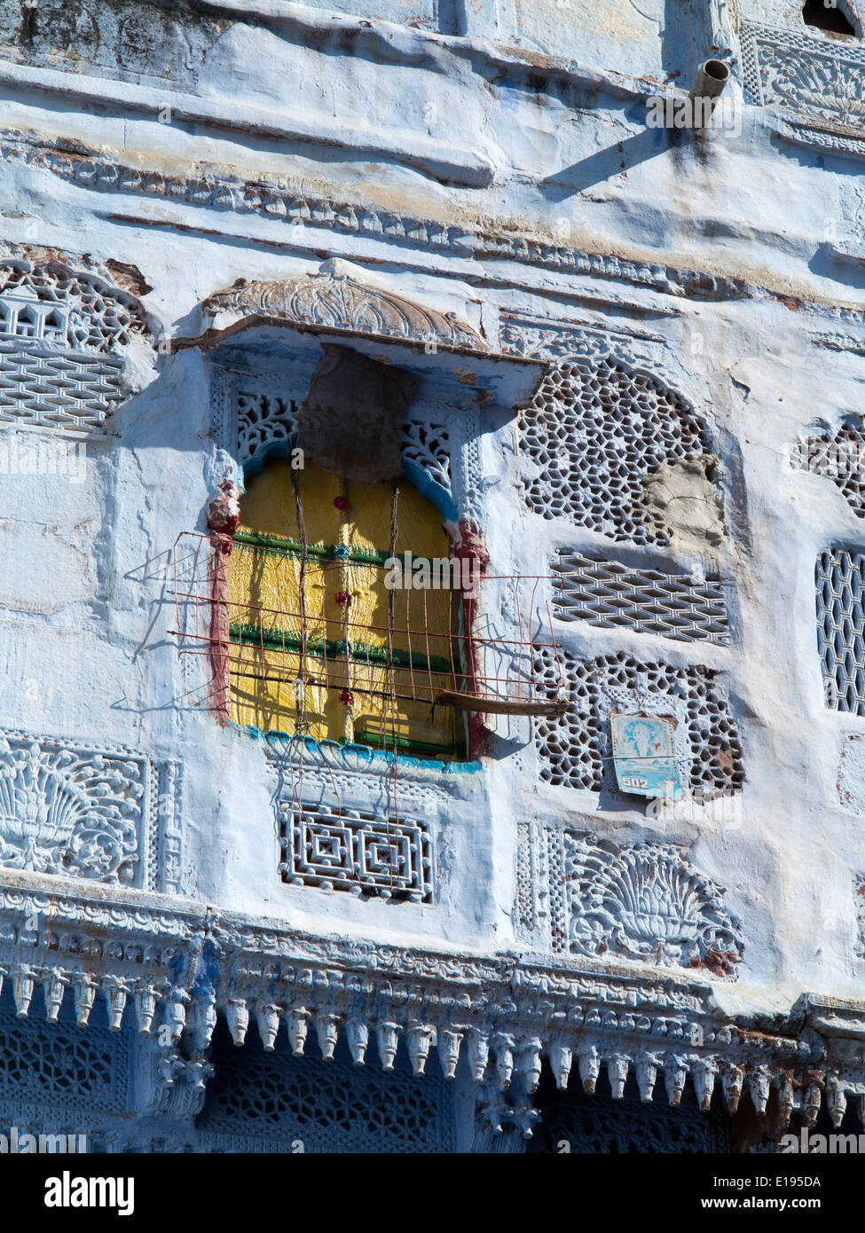 India, Rajasthan, Jodhpur, crudely barred window of blue painted house ...