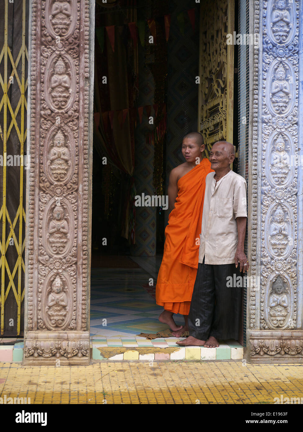 Monk and old man outside temple in Cambodia Stock Photo - Alamy