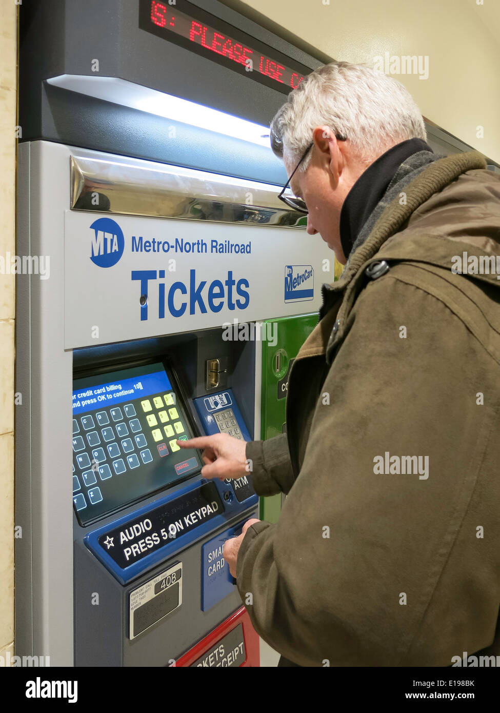 Man Purchasing Metro North Transit Train Tickets at Self Serve Vending ...