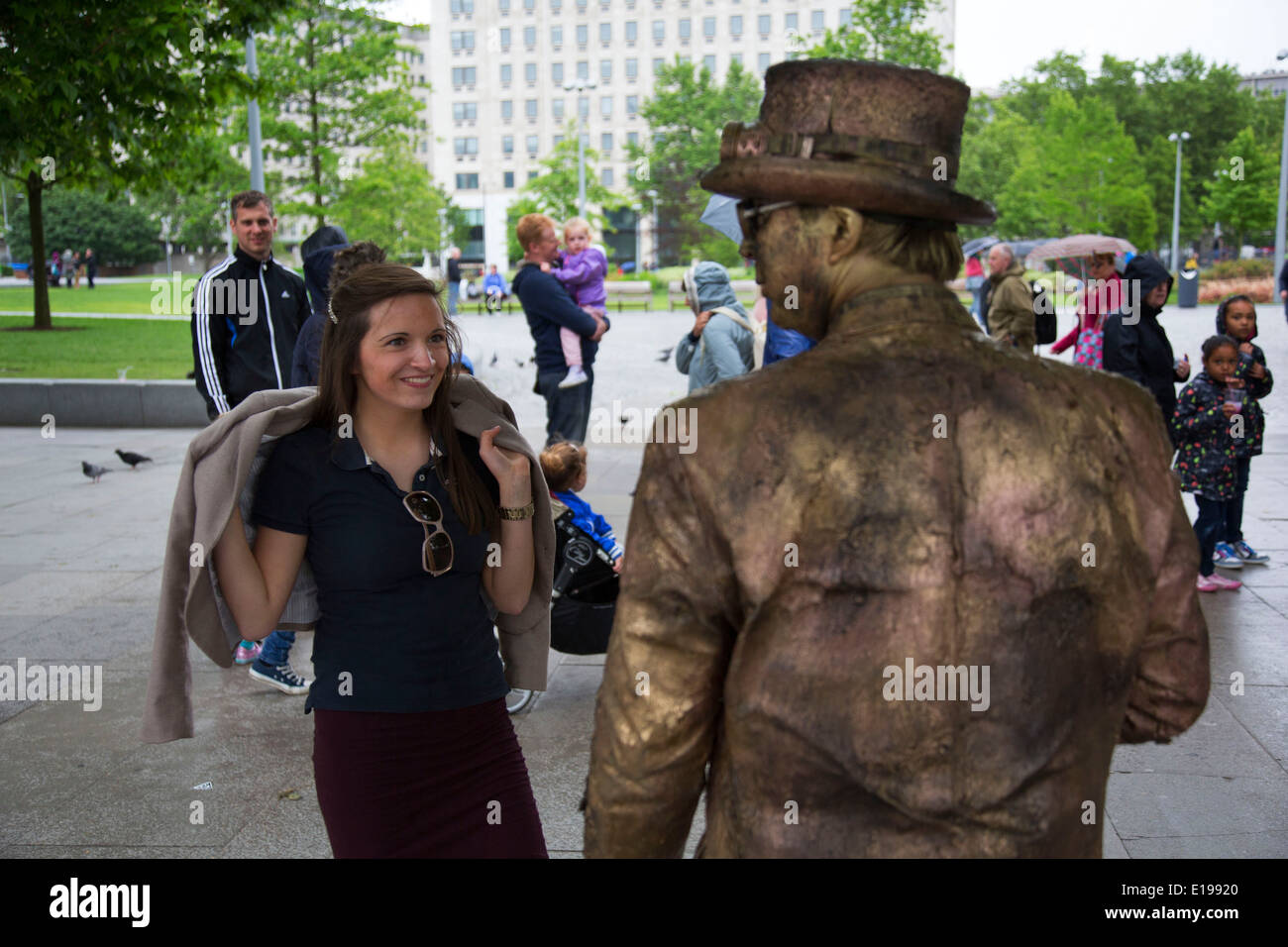 Gravity defying gold street performer, living statue, entertains people ...