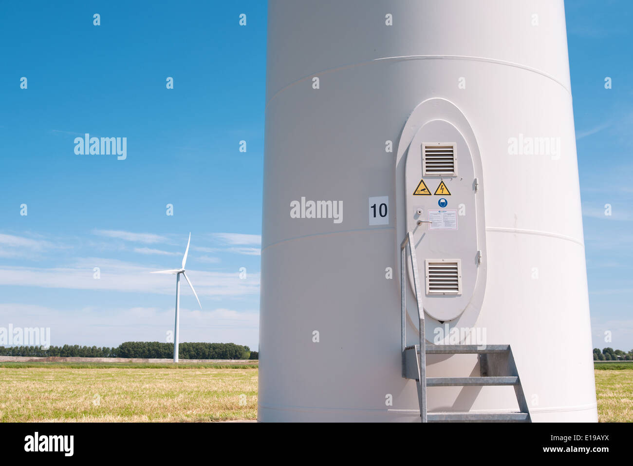 main entrance of a wind turbine in a wind mill area with wind mill in ...
