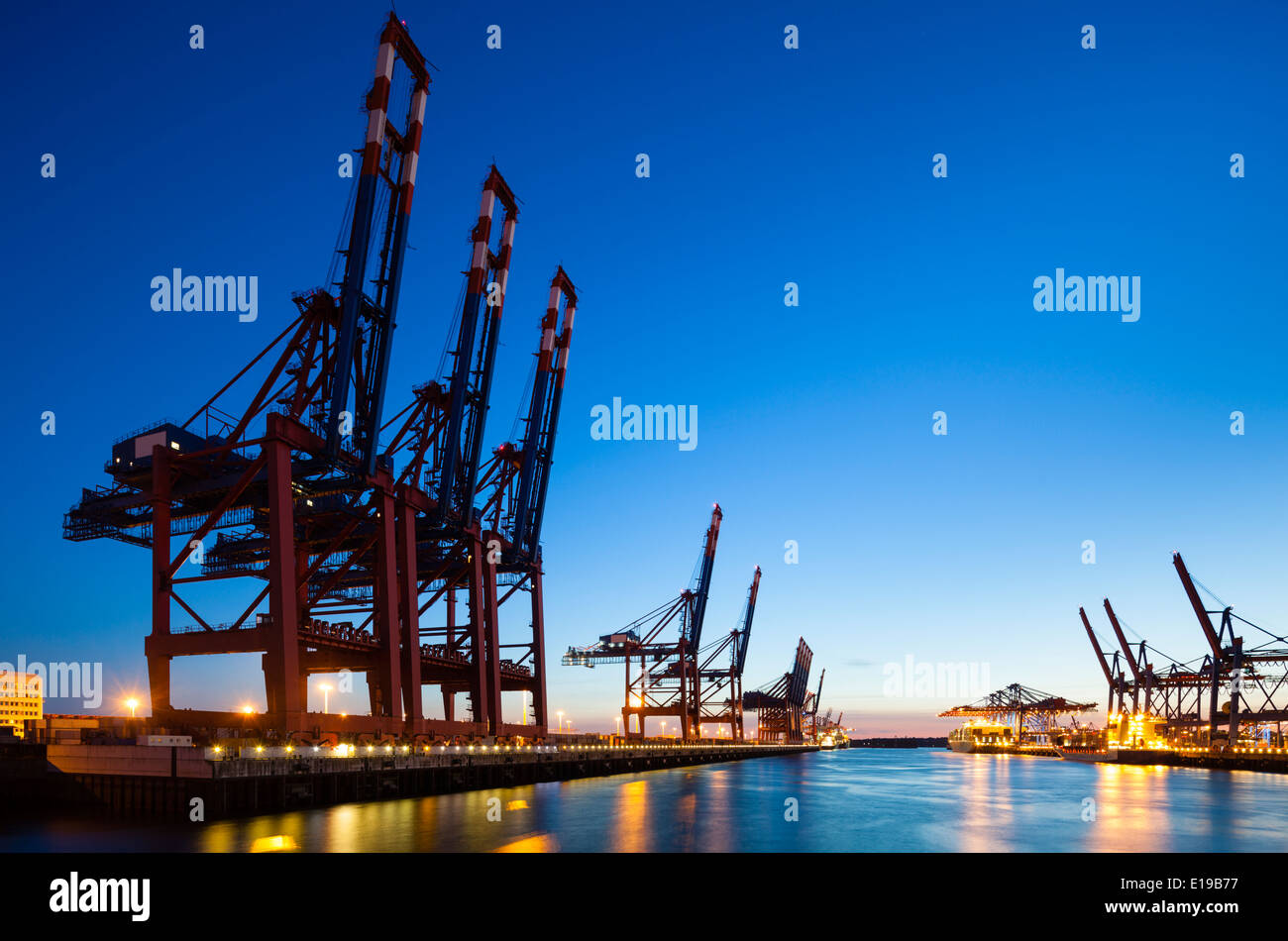 A large container harbor with deep blue night sky, taken with a shift ...