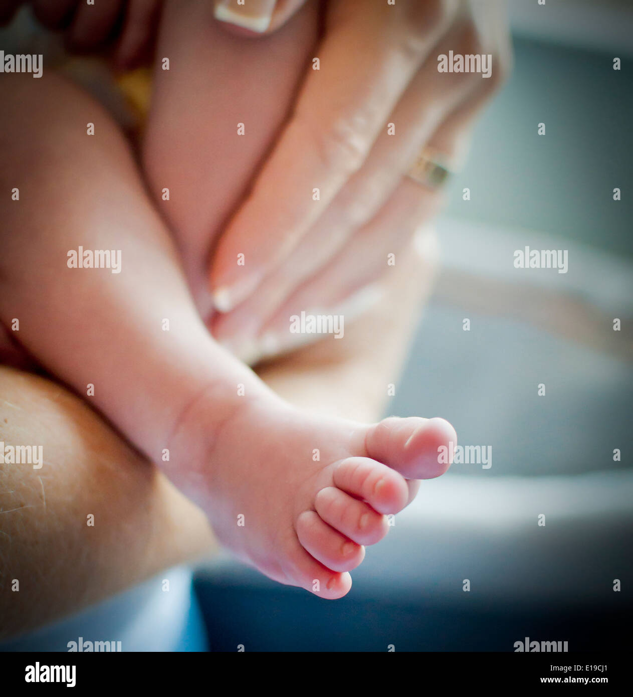 Baby holding toes hi-res stock photography and images - Alamy