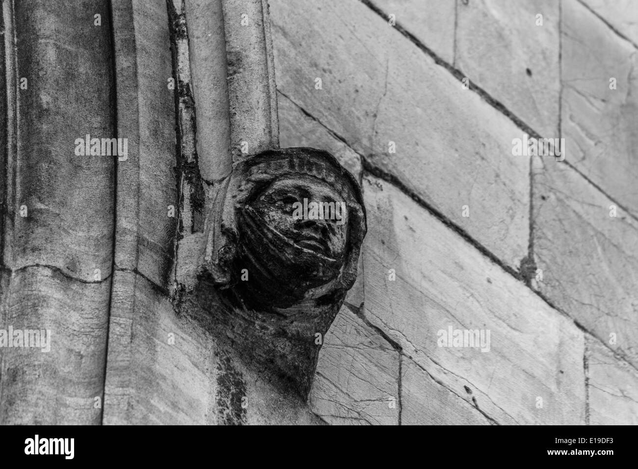 Close up of a stone face on the side of a church wall Stock Photo - Alamy
