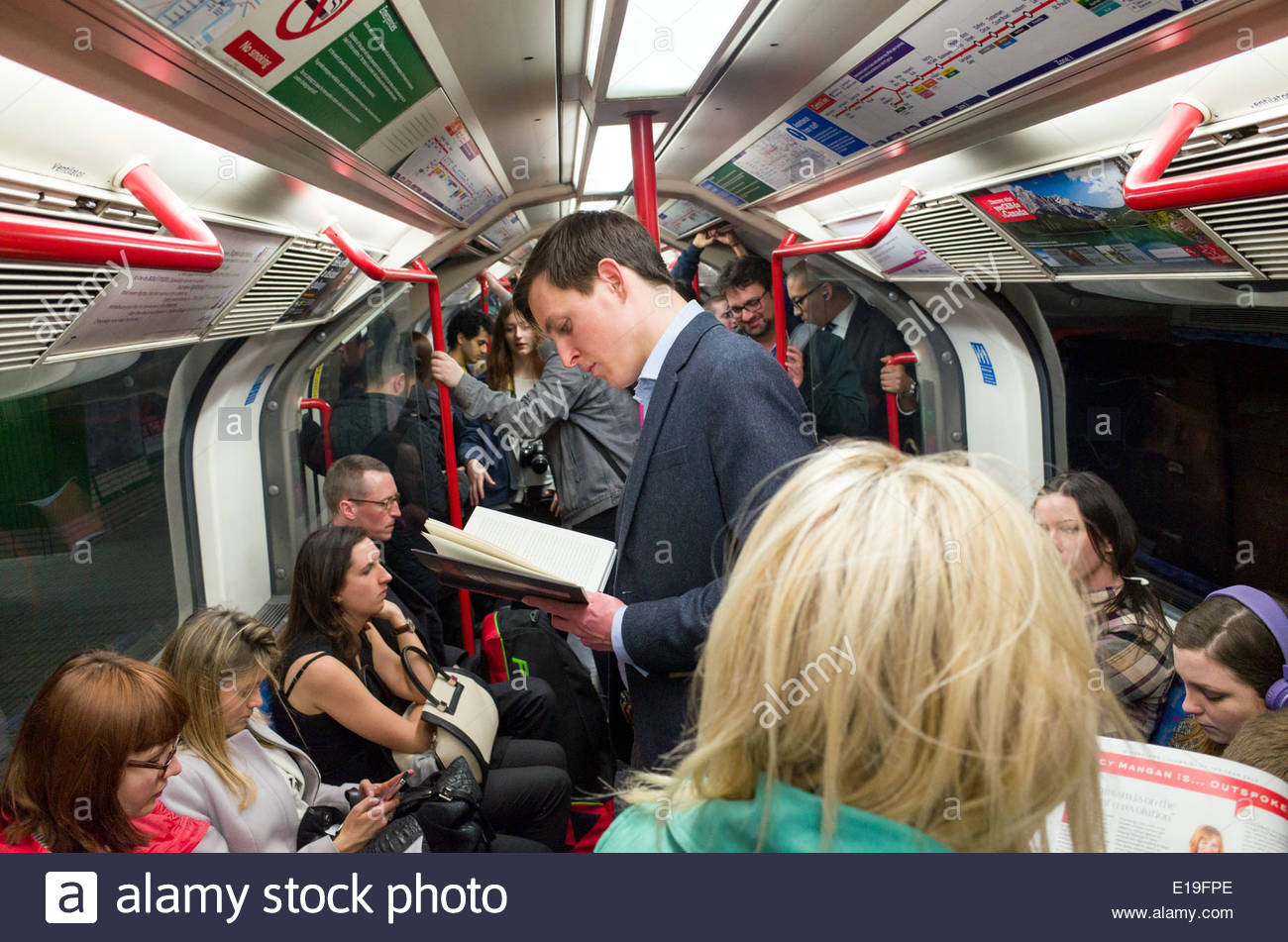 Commuters standing on a crowded London Underground train carriage Stock ...