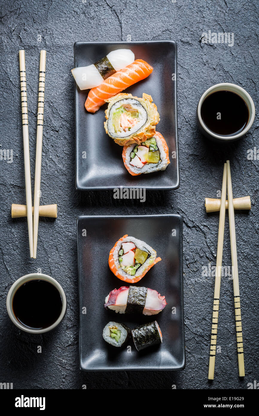 Sushi for two served on black stone Stock Photo - Alamy